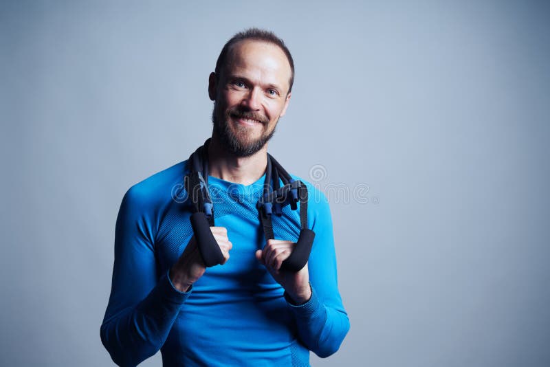 Mid Age Slim Smiling Man with Sport Rubber Expander Over Shoulders ...