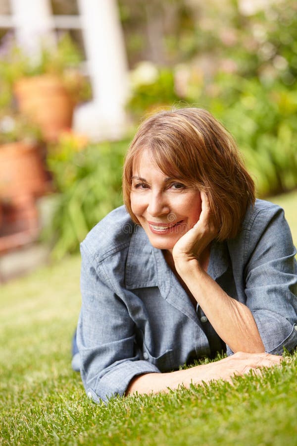 Mid Age Woman Relaxing in Garden Stock Image - Image of hispanic ...