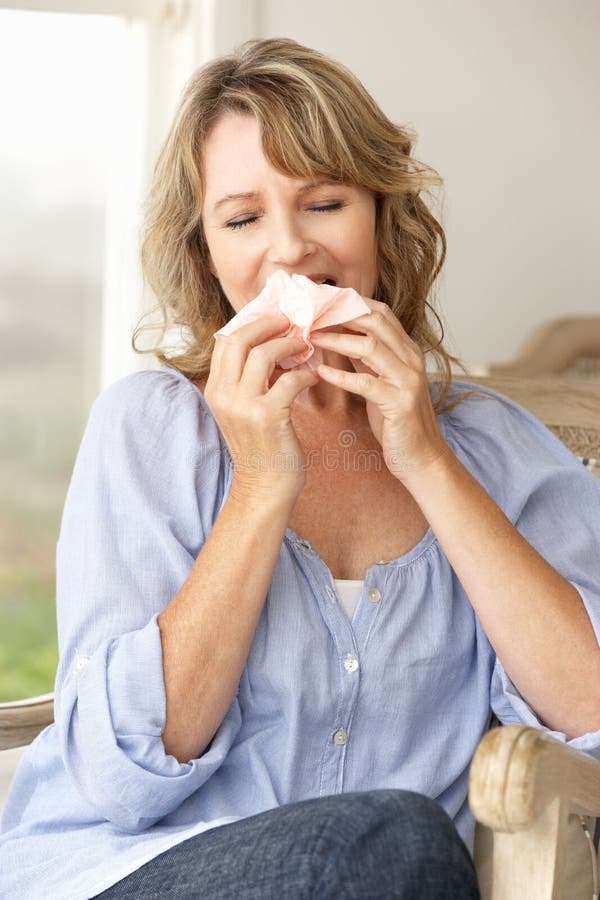 Mid age woman sneezing stock photo. Image of shoulders - 21029348