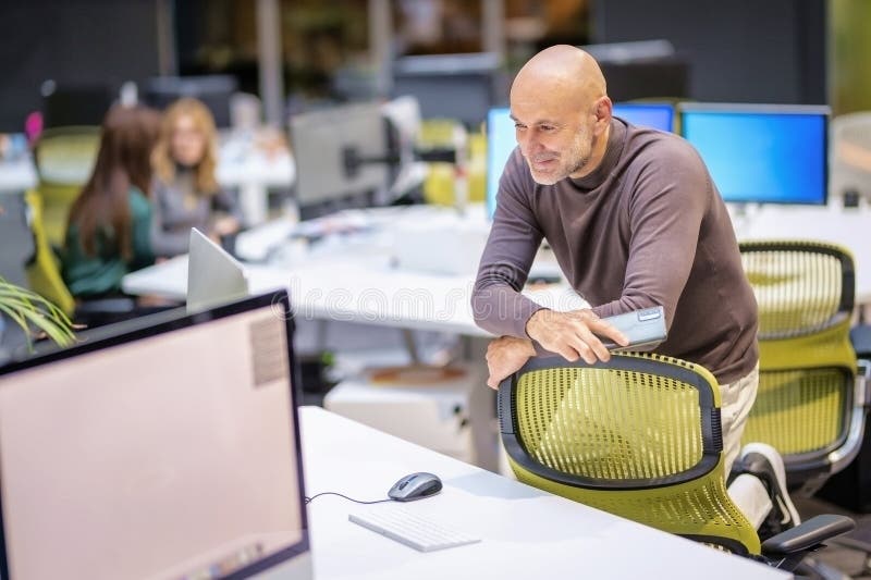 Mid Aged Businessman Standing at the Office and Using Computers for ...