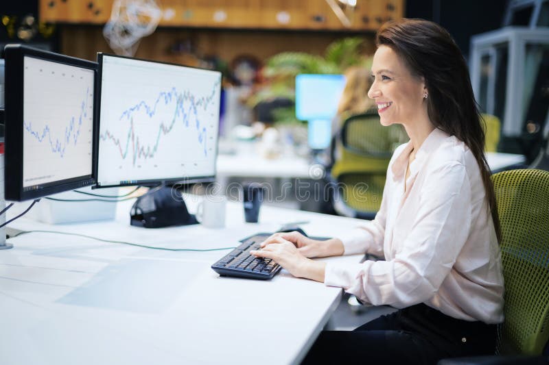 Confdient Professional Woman Sitting at Desk and Surrounded by ...