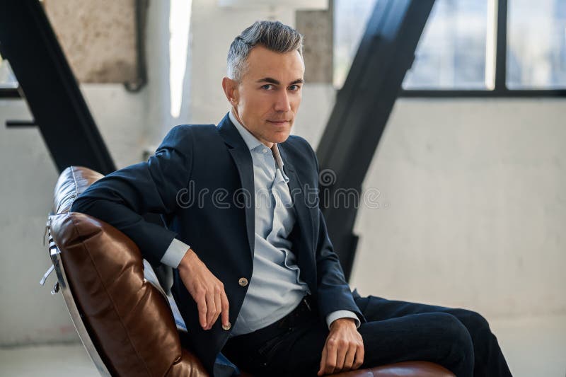 Mid Aged Good-looking Man Sitting in the Office and Looking Confident ...