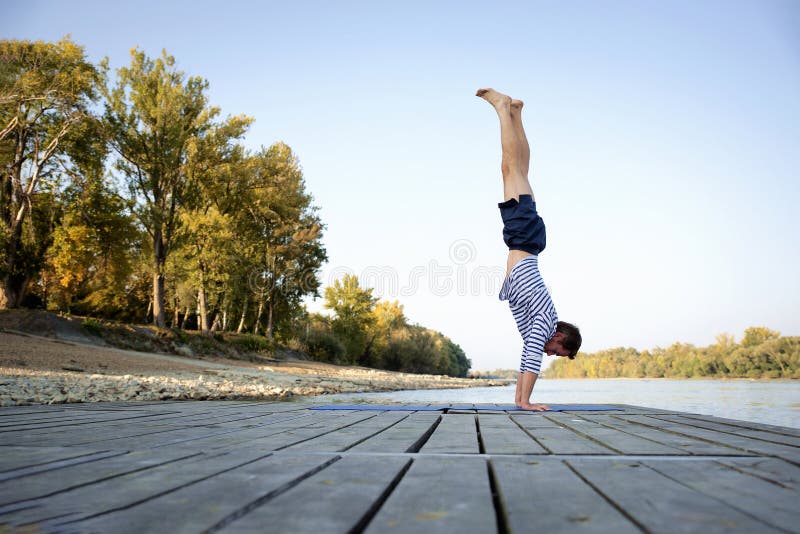 Mid Aged Man Practicing Yoga Pose Handstand Outdoor Stock Photo - Image ...