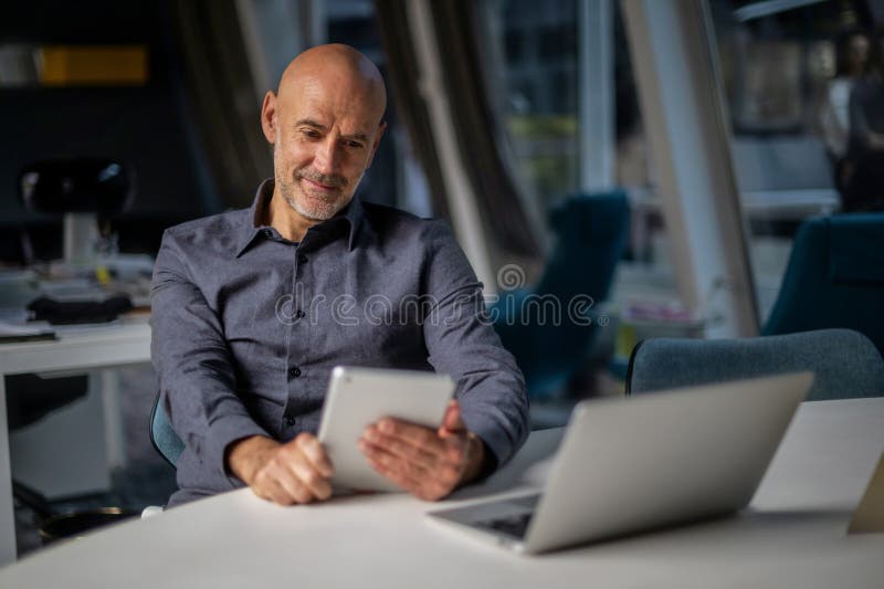 Mid Aged Professional Man Sitting at the Office and Using Touchpad and ...