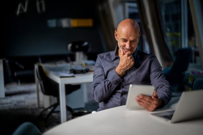 Mid Aged Professional Man Sitting at the Office and Using Touchpad and ...