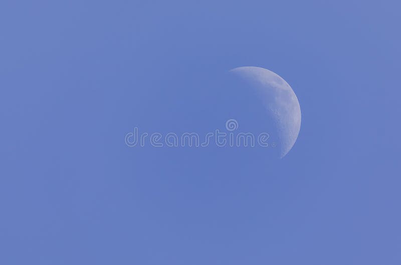 Mid-phase of the Moon on a Blue Sky Background Stock Image - Image of ...