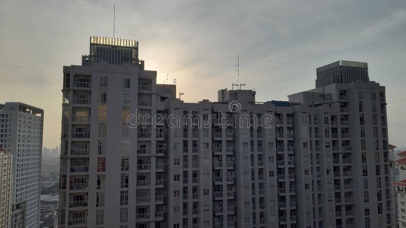 A Mid-rise Apartment Building with a Light-colored Facade Stands ...