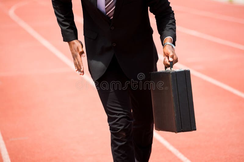 Mid Section of Businessman Running on a Running Track Stock Photo ...
