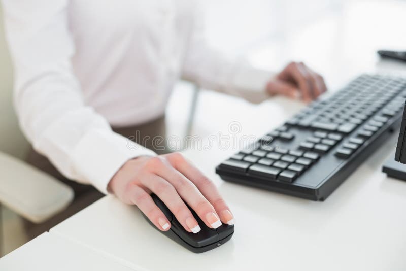 Mid Section of Businesswoman Using Mouse in Office Stock Image - Image ...
