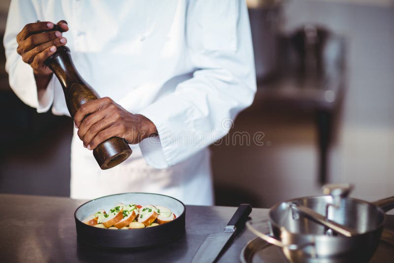 Mid Section of Chef Sprinkling Pepper on a Meal Stock Image - Image of ...
