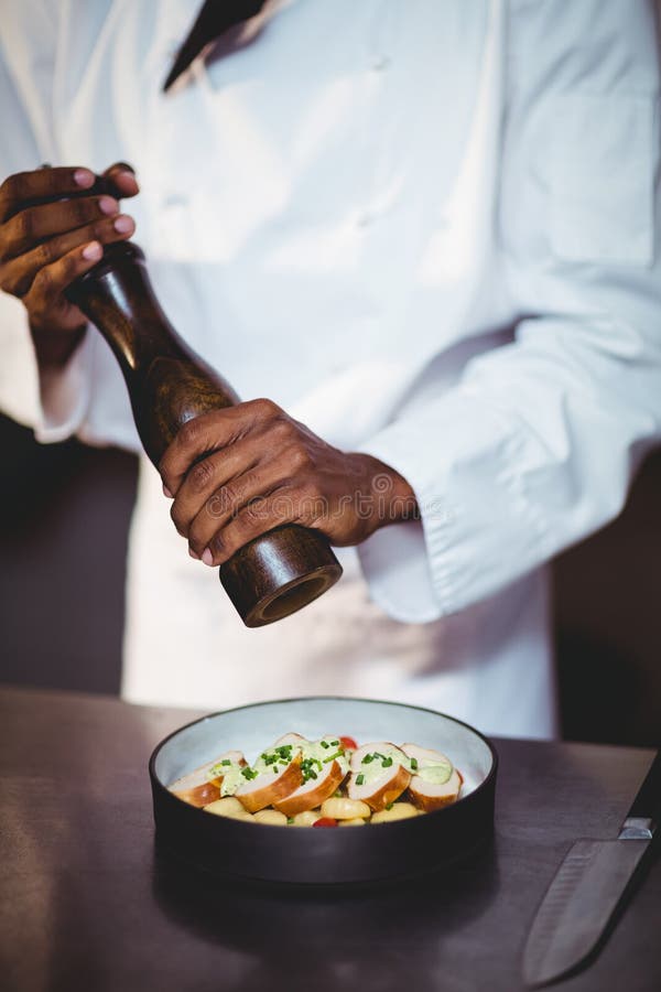 Mid Section of Chef Sprinkling Pepper on a Salad Stock Image - Image of ...