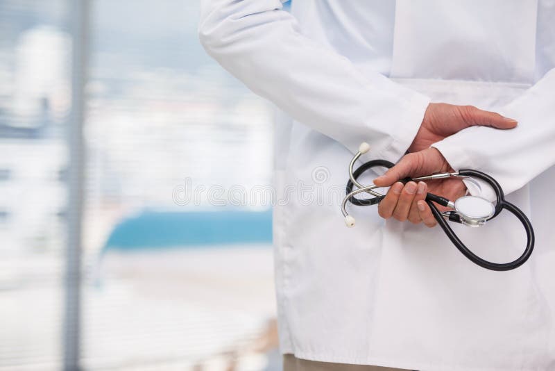 Mid-section of Doctor Holding Stethoscope Stock Image - Image of ...