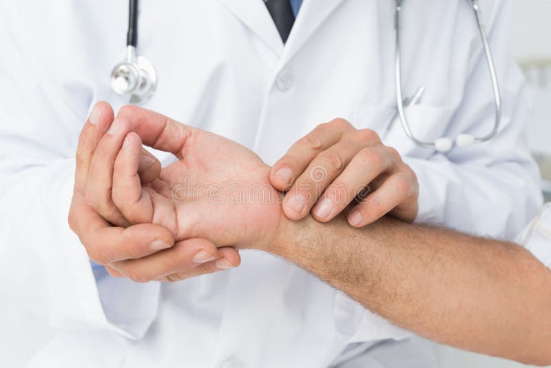 Mid Section of a Doctor Taking a Patients Pulse Stock Photo - Image of ...