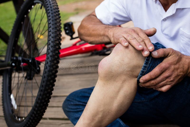 Mid Section of Fallen Cyclist Holding His Injured Knee Stock Image ...