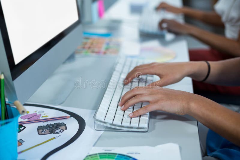 Mid Section of Female Graphic Designers Working on Personal Computer ...