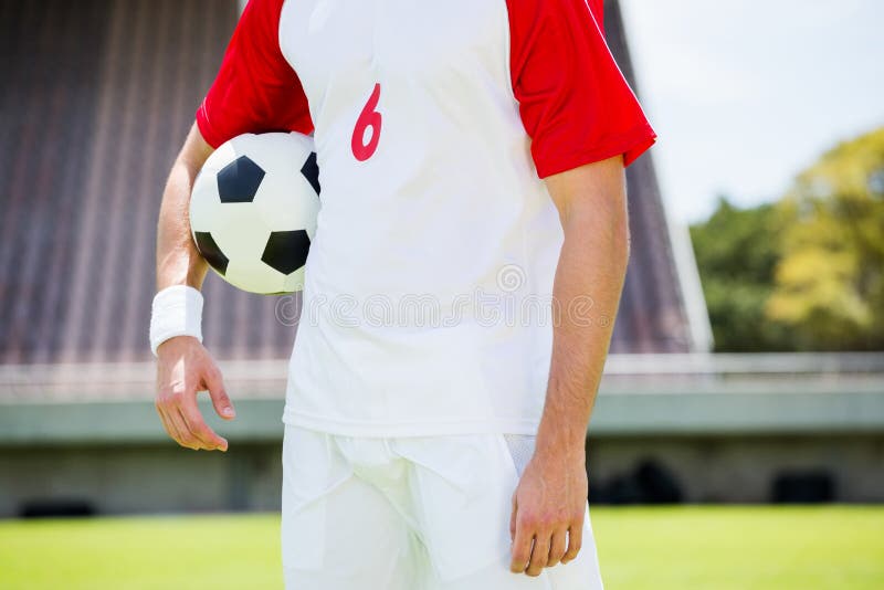 Mid Section of Football Player Standing with a Ball Stock Photo - Image ...