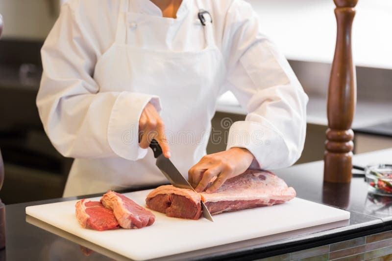 Mid Section of Hands Cutting Meat in Kitchen Stock Photo - Image of ...