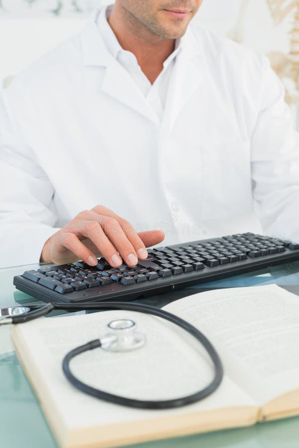 Doctor Using Computer and Telephone at Office Stock Photo - Image of ...