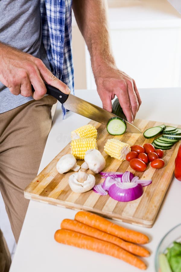 Mid Section of a Man Chopping Vegetables in Kitchen Stock Image - Image ...