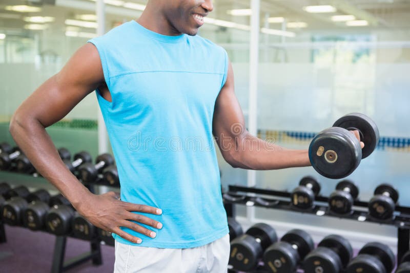 Mid Section of Man Exercising with Dumbbell in Gym Stock Photo - Image ...