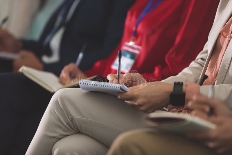 Business People Writing on Notepad in a Business Seminar Stock Image ...