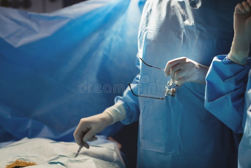 Mid Section of Surgeons Performing Operation in Operation Room Stock ...