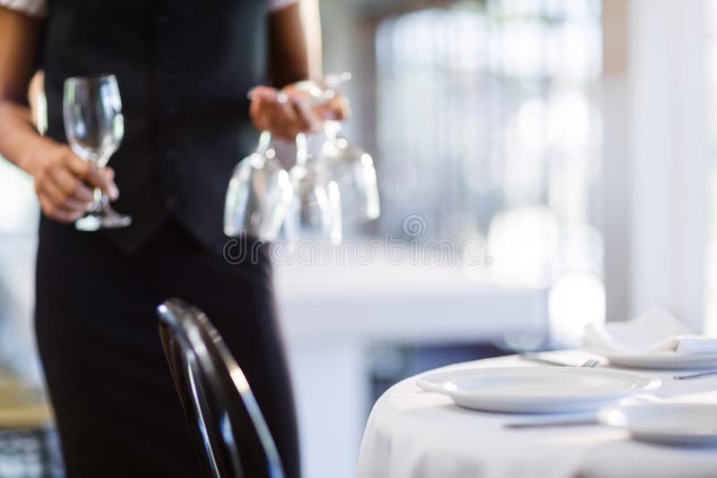 Mid Section of Waitress Setting the Table Stock Image - Image of ...