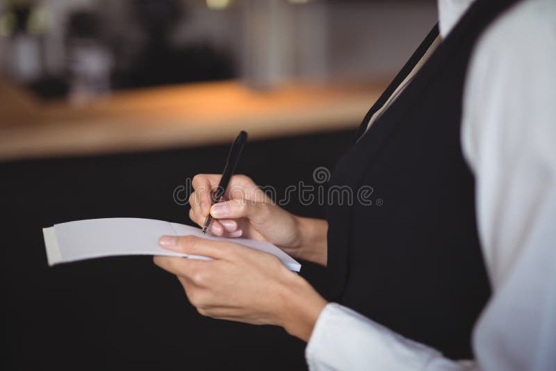 Mid-section of Waitress Writing Order on Notepad Stock Image - Image of ...