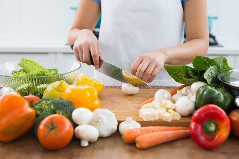 Mid Section of a Woman Chopping Vegetables in Kitchen Stock Image ...