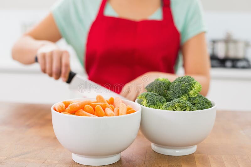 Mid Section of a Woman Chopping Vegetables in Kitchen Stock Image ...