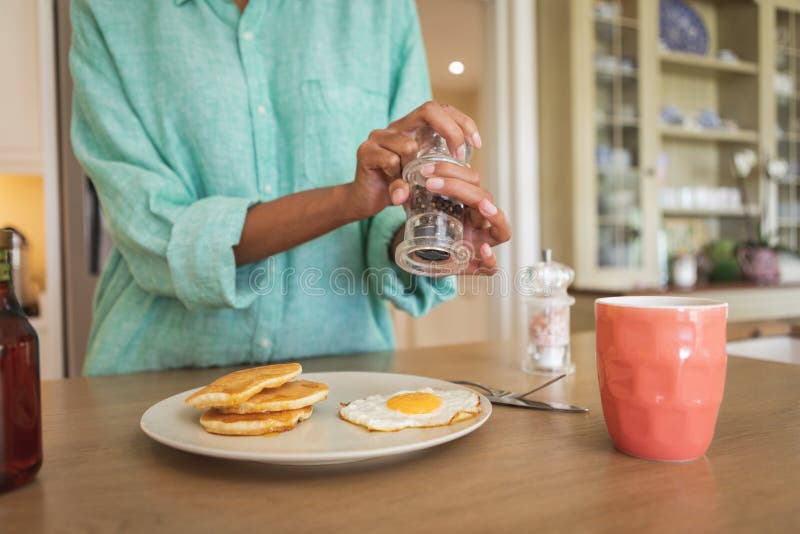Mid Section of Woman Putting Salt on Cooked Eggs Stock Photo - Image of ...