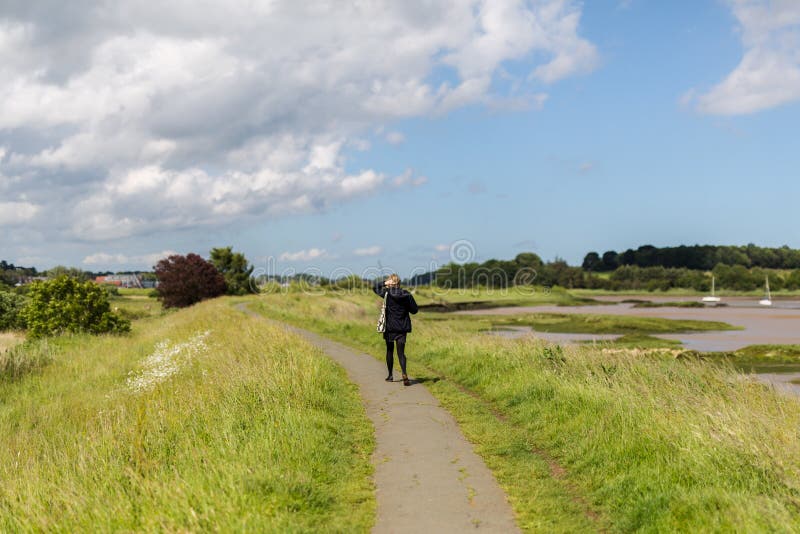 A Mid 20 Something Female Walking Away from the Camera Along a Path Way ...