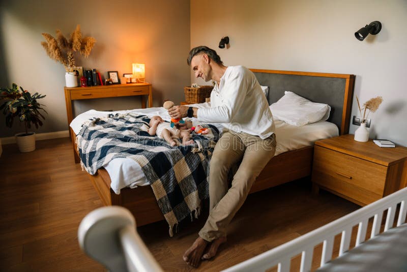 Mid White Father Smiling while Spending Time with His Baby Stock Photo ...