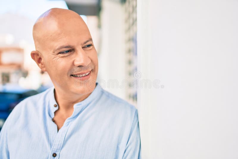 Middle Age Bald Man Smiling Happy Leaning on the Wall at the City Stock ...