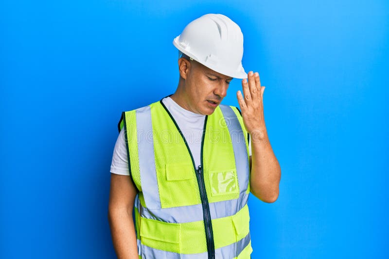 Middle Age Bald Man Wearing Architect Hardhat Surprised with Hand on ...