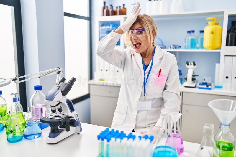Middle Age Blonde Woman Working at Scientist Laboratory Surprised with ...