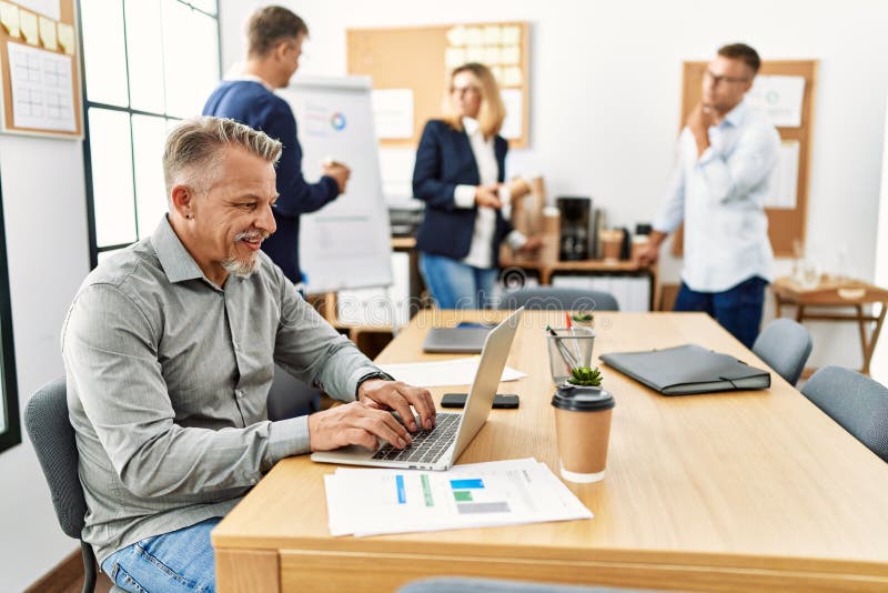 Middle Age Business Worker Smiling Happy Working while Partners Have ...