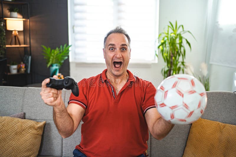 Middle Age Caucasian Man Playing Soccer Video Game at Home Stock Photo ...
