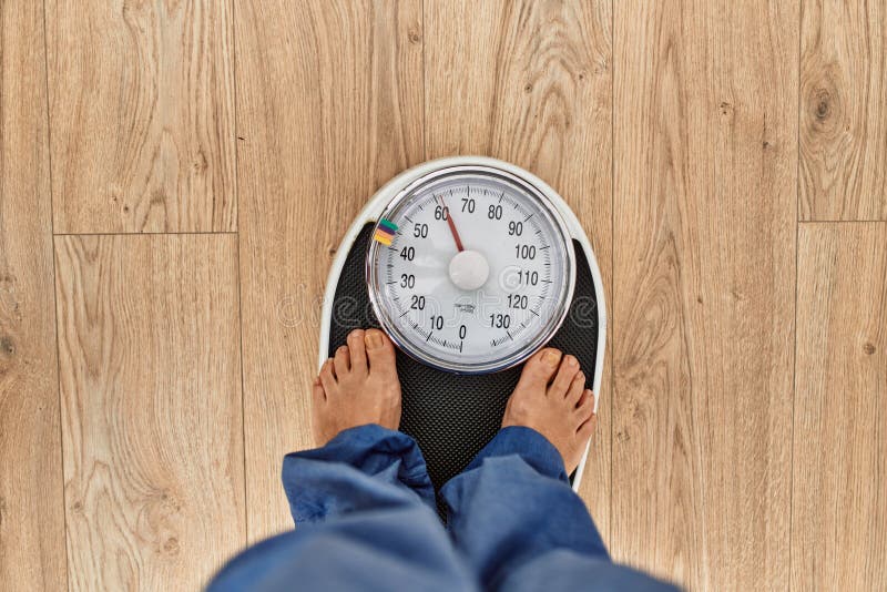 Middle Age Caucasian Woman Using Weighing Machine at Home Stock Photo ...