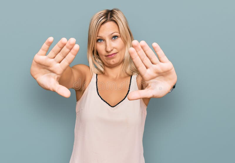 Middle Age Caucasian Woman Wearing Casual Clothes Doing Frame Using