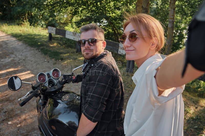 Middle Age Couple Riding a Motorcycle Having Fun and Taking Selfies ...