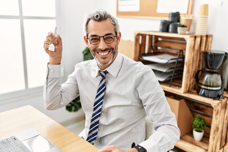 Middle Age Grey-haired Man Real State Agent Holding Key of New Home at ...
