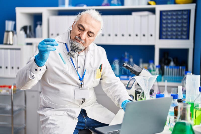 Middle Age Grey-haired Man Scientist Using Laptop Holding Test Tube at ...