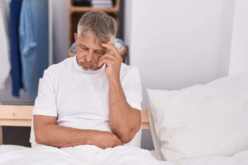 Middle Age Grey-haired Man Stressed Sitting on Bed at Bedroom Stock ...