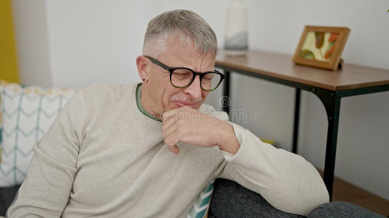 Middle Age Grey-haired Man Stressed Sitting on Sofa Crying at Home ...