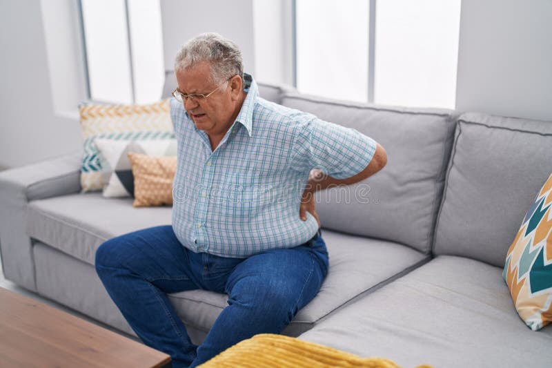 Middle Age Grey-haired Man Suffering for Backache Sitting on Sofa at ...