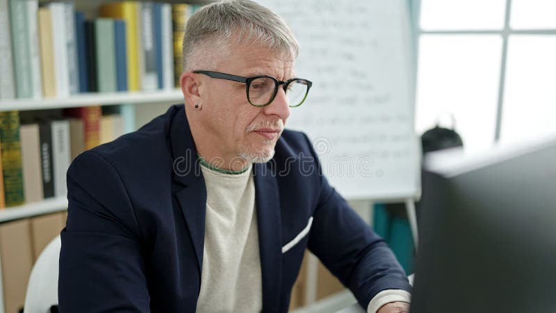 Middle Age Grey-haired Man Teacher Using Computer Studying at ...