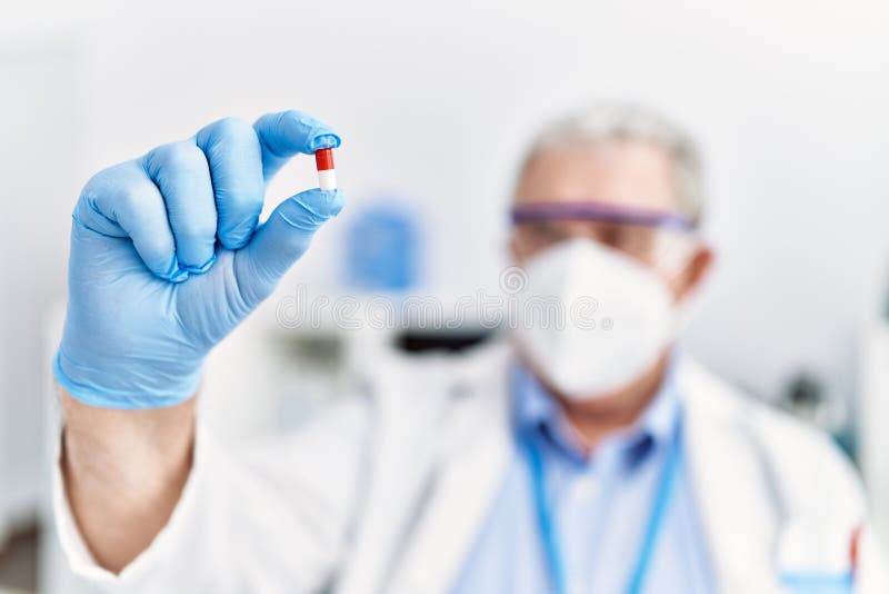 Middle Age Grey-haired Man Wearing Scientist Uniform Hoding Pill at ...