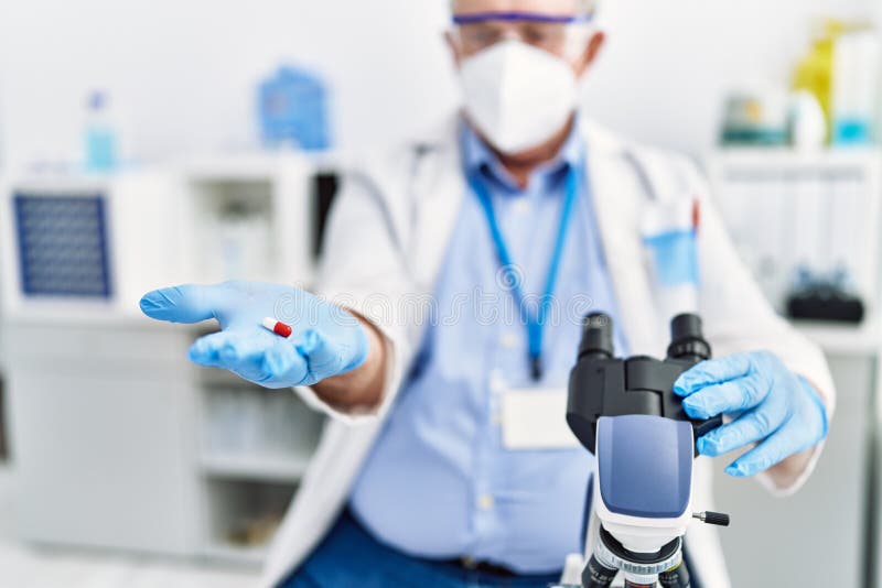 Middle Age Grey-haired Man Wearing Scientist Uniform Hoding Pill at ...