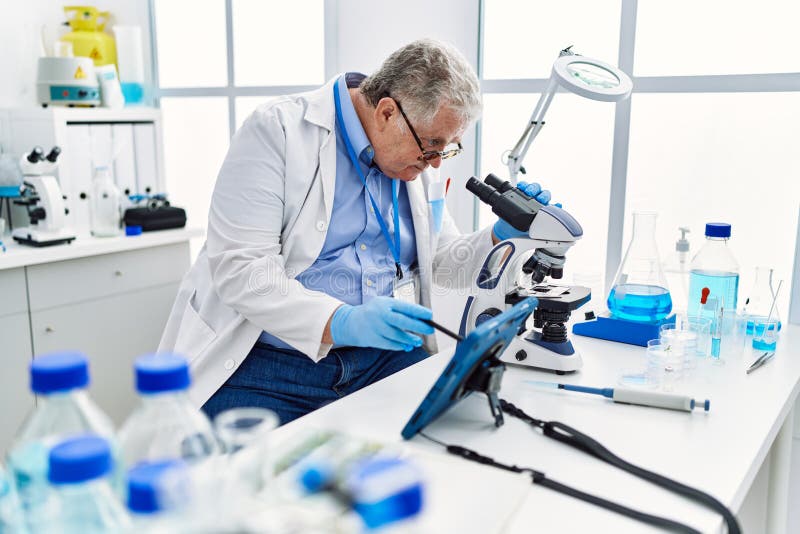Middle Age Grey-haired Man Wearing Scientist Uniform Using Microscope ...